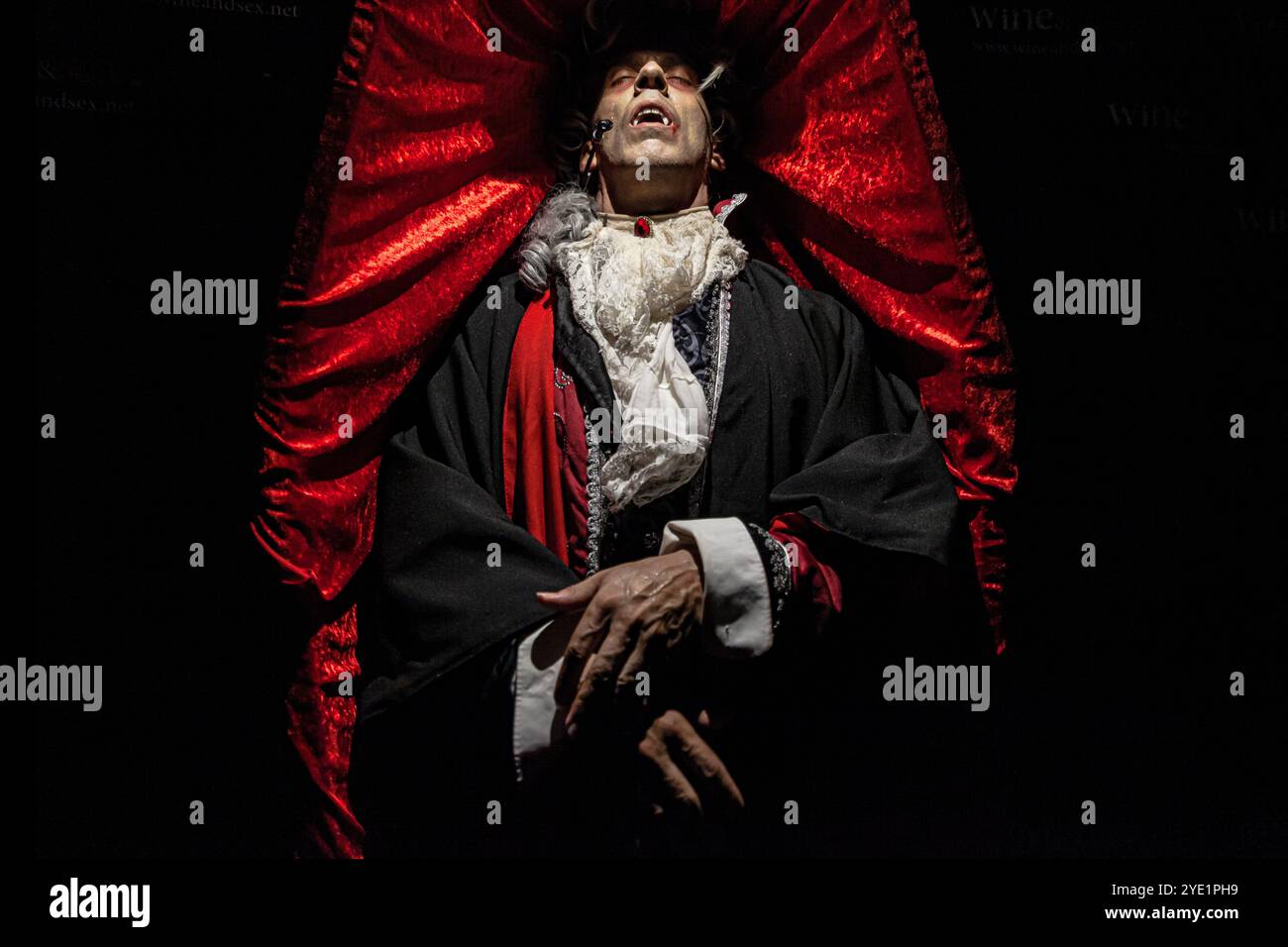 Actor dressed up like Dracula lying on a red velvet coffin Stock Photo ...