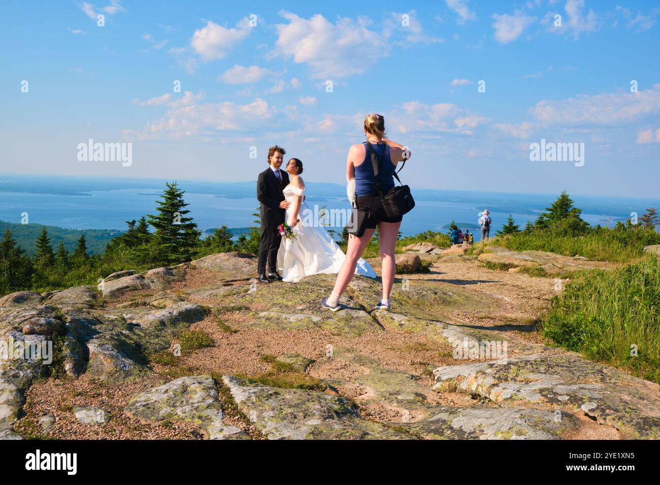 A new bride, groom getting wedding photos taken. At Cadillac summit ...