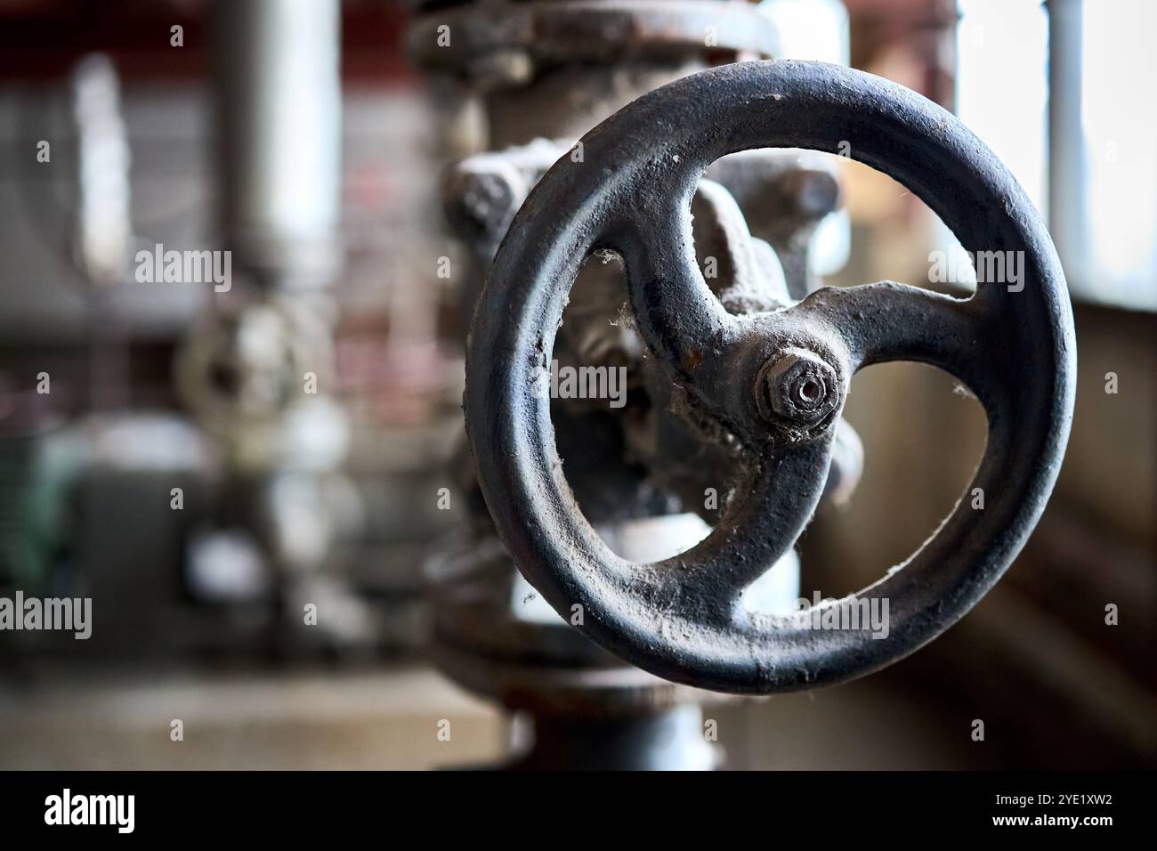 Industrial dusty chemical petrochemical retro style valve closeup with ...