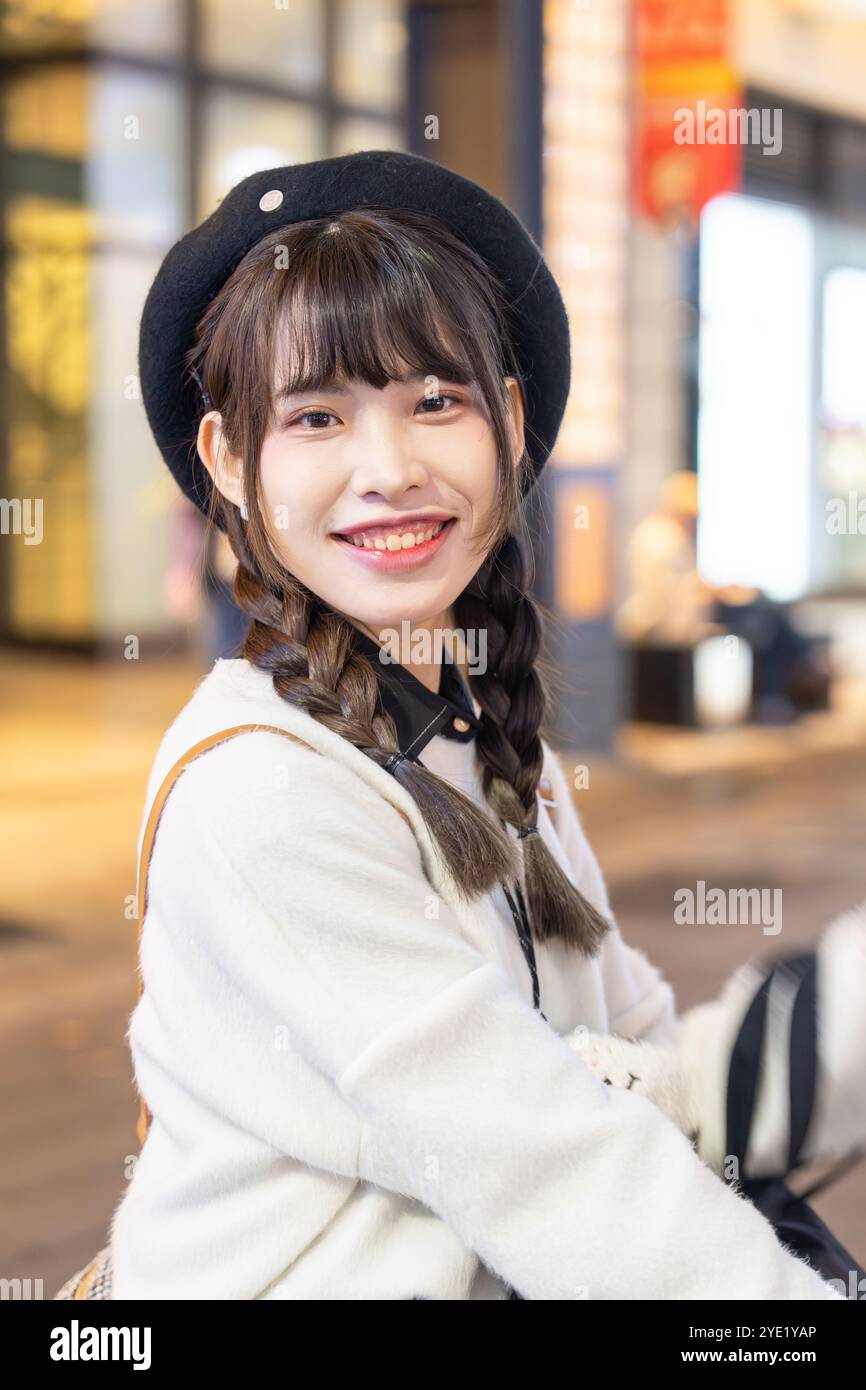 A young and cute Taiwanese woman in her 20s wearing black and white ...