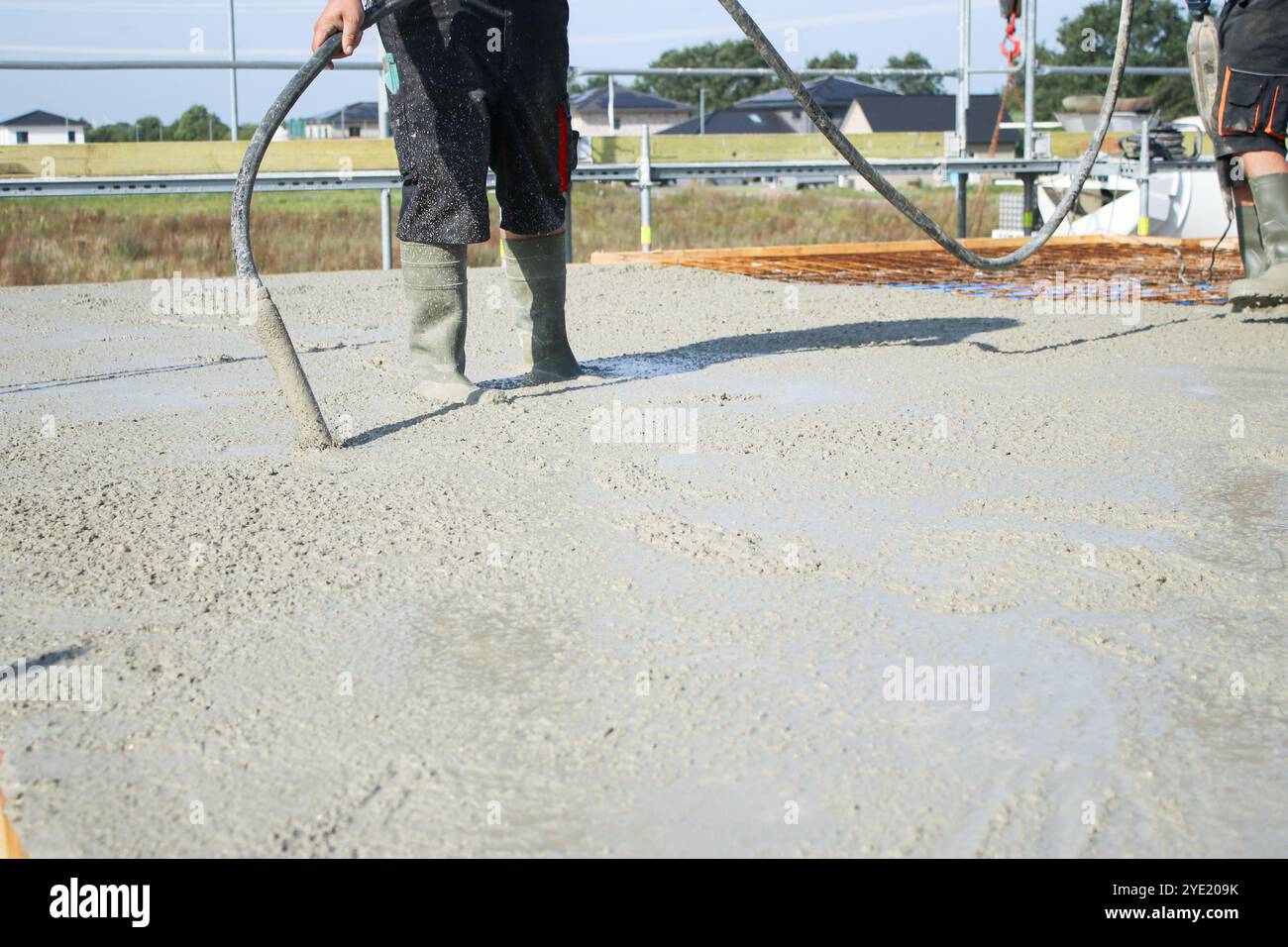 Workers filling the second floor ground with concrete, core and shell ...