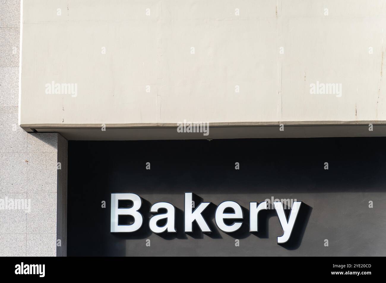 Monochrome Bakery Signage: Light and Shadow on a Textured Wall Stock ...