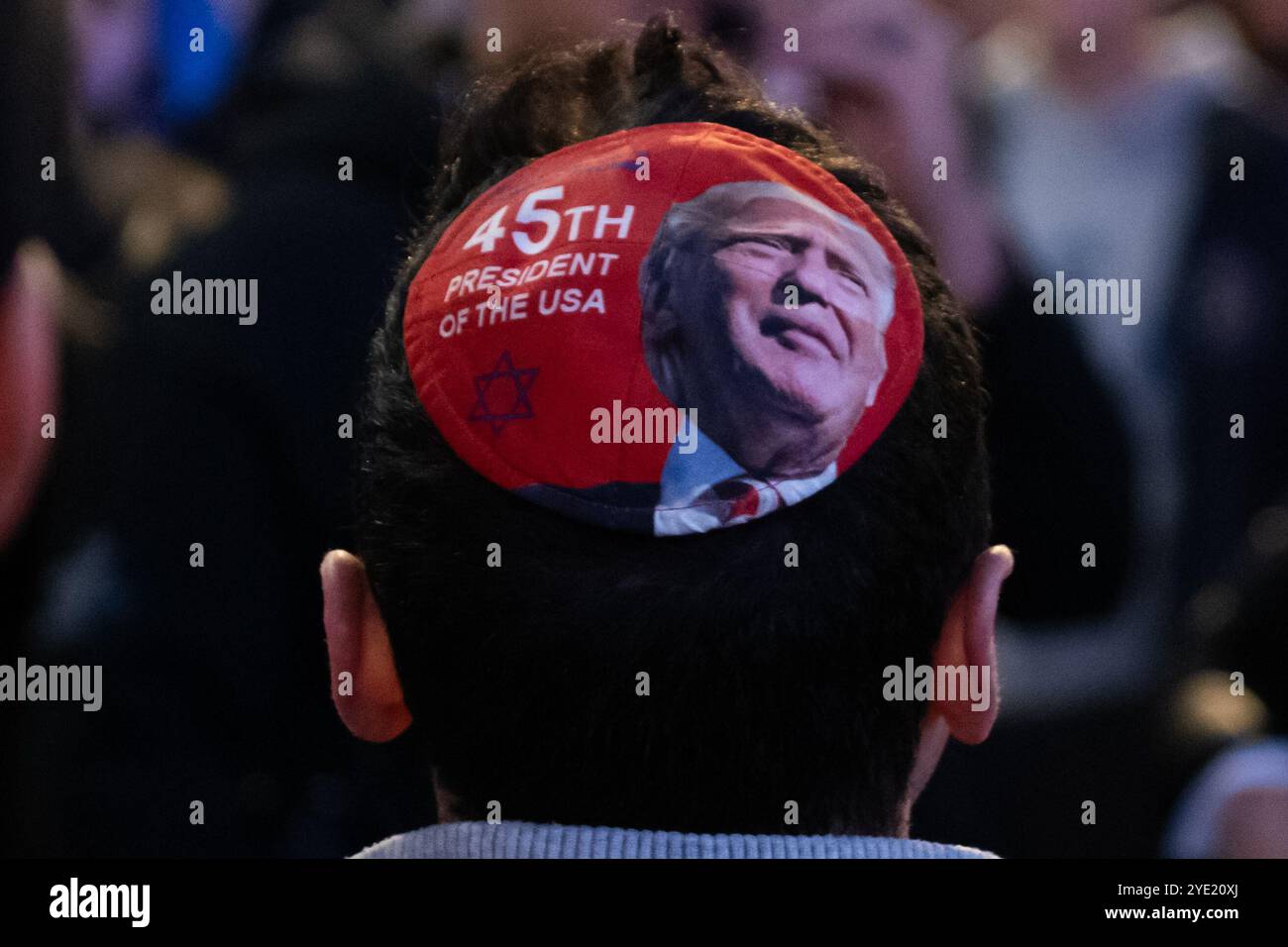 A man wears a yarmulke with a image of Donald Trump and the text 45th ...