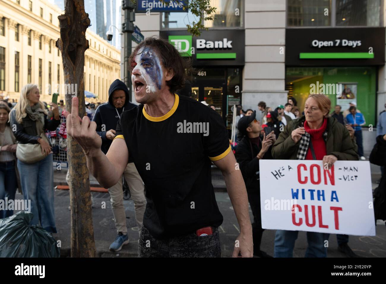 A man gives the middle finger to people protesting Donald Trump's rally ...