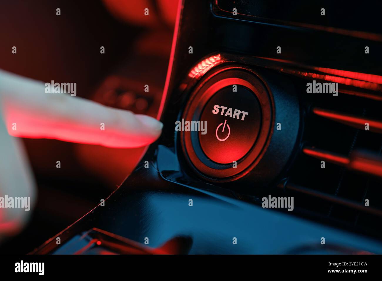 hand pressing start button on car panel, action activation concept ...