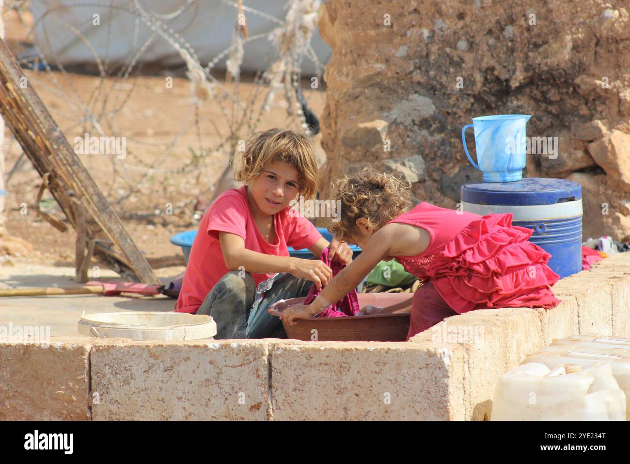 Two small children could wash clothes working a primitive way in one of ...