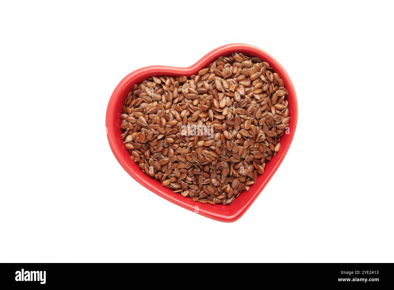 Healthy food. Flax seeds in red heart shaped bowl isolated on white background. Top view Stock ...