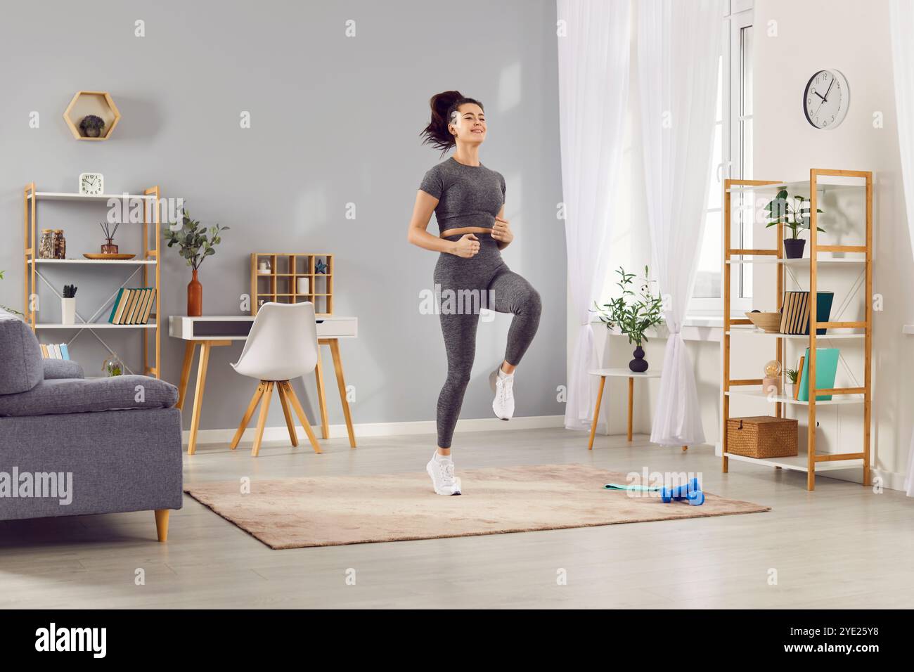 Woman Jogging In Place During Home Workout Session Stock Photo - Alamy