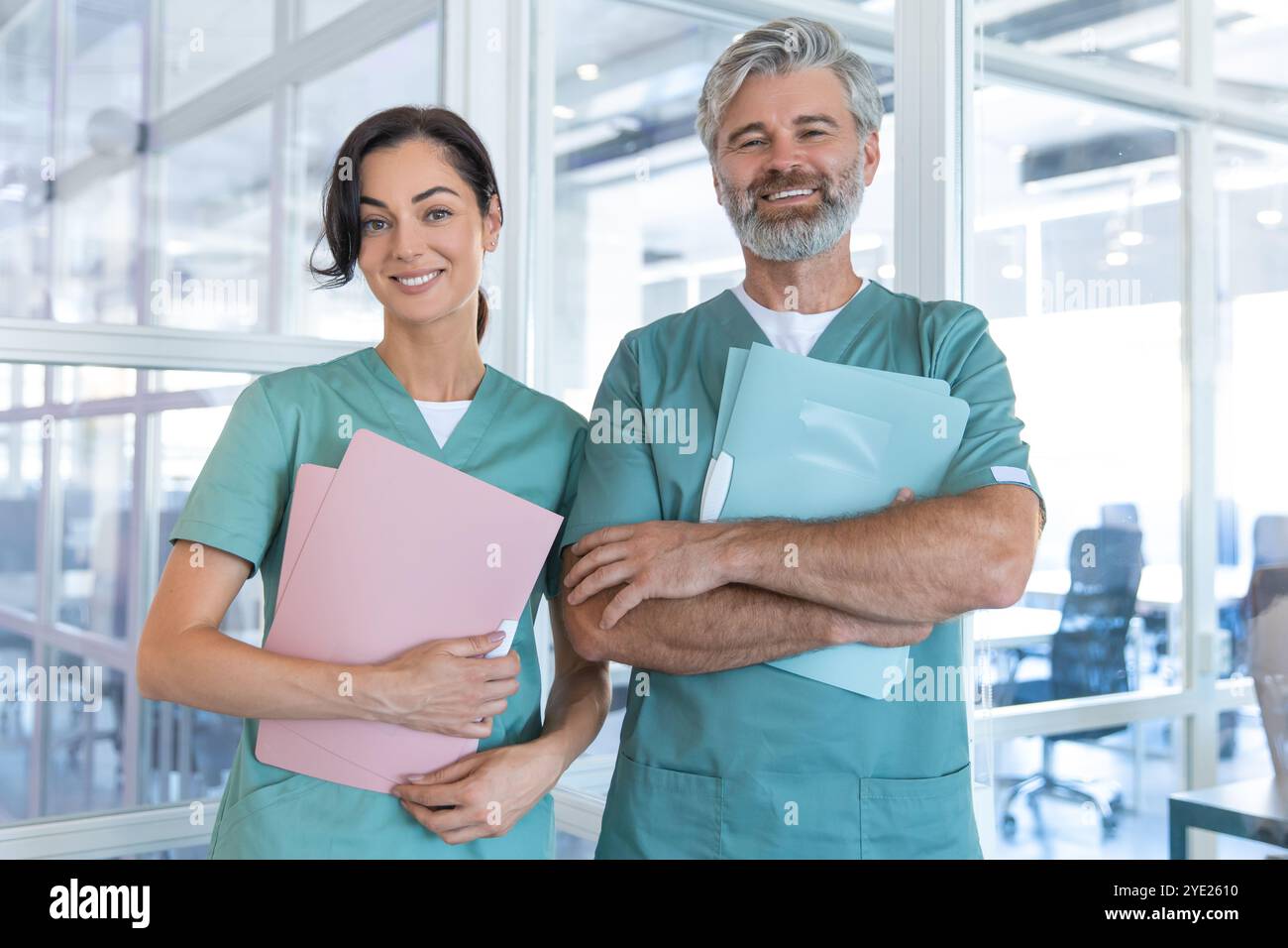 Two doctors standing in the clinic corridor and looking confident Stock ...
