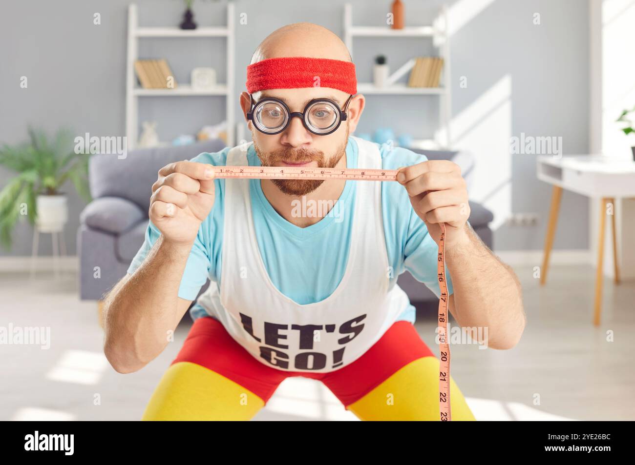 Funny Man Measuring With Tape During Home Fitness Training Stock Photo ...