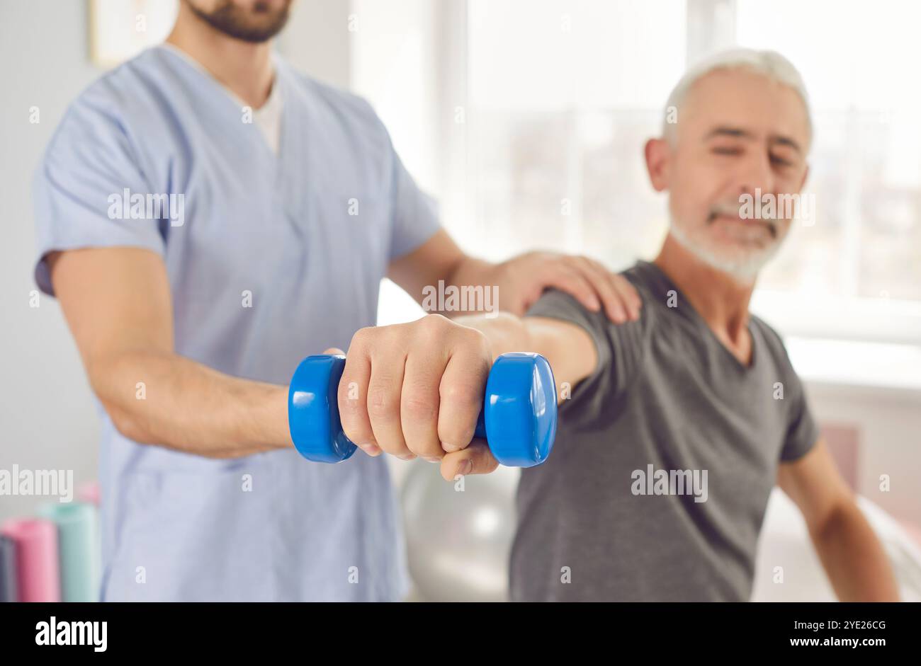 Physiotherapist helps old man exercise hi-res stock photography and ...
