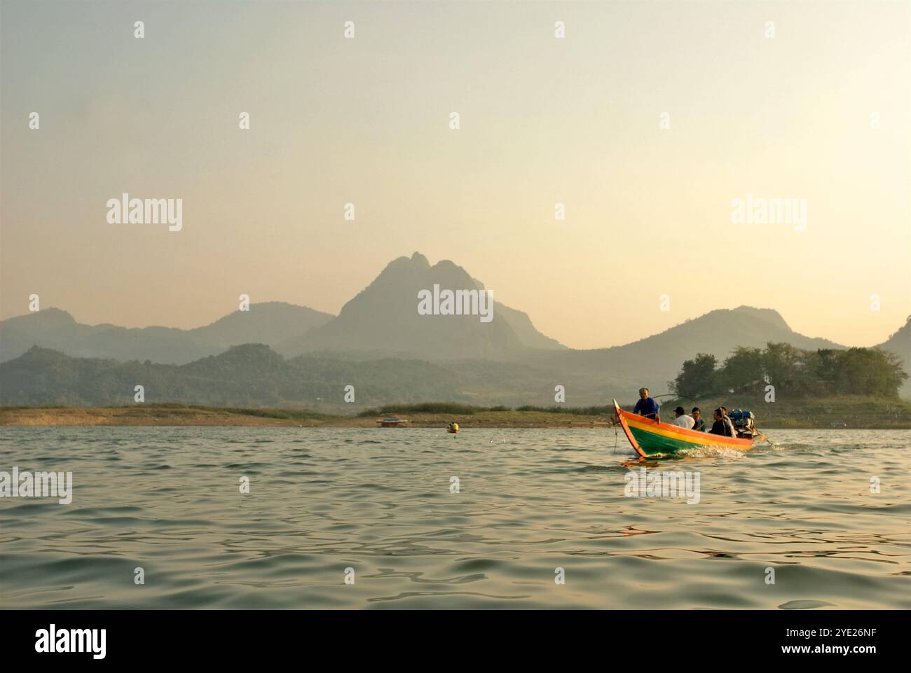 A motorized boat transporting people across Jatiluhur dam in West Java ...