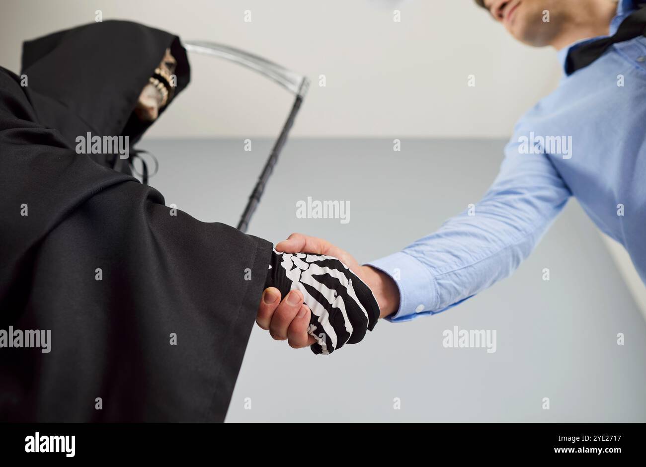 Man Shaking Hand with Grim Reaper Signing Soul Contract Stock Photo - Alamy