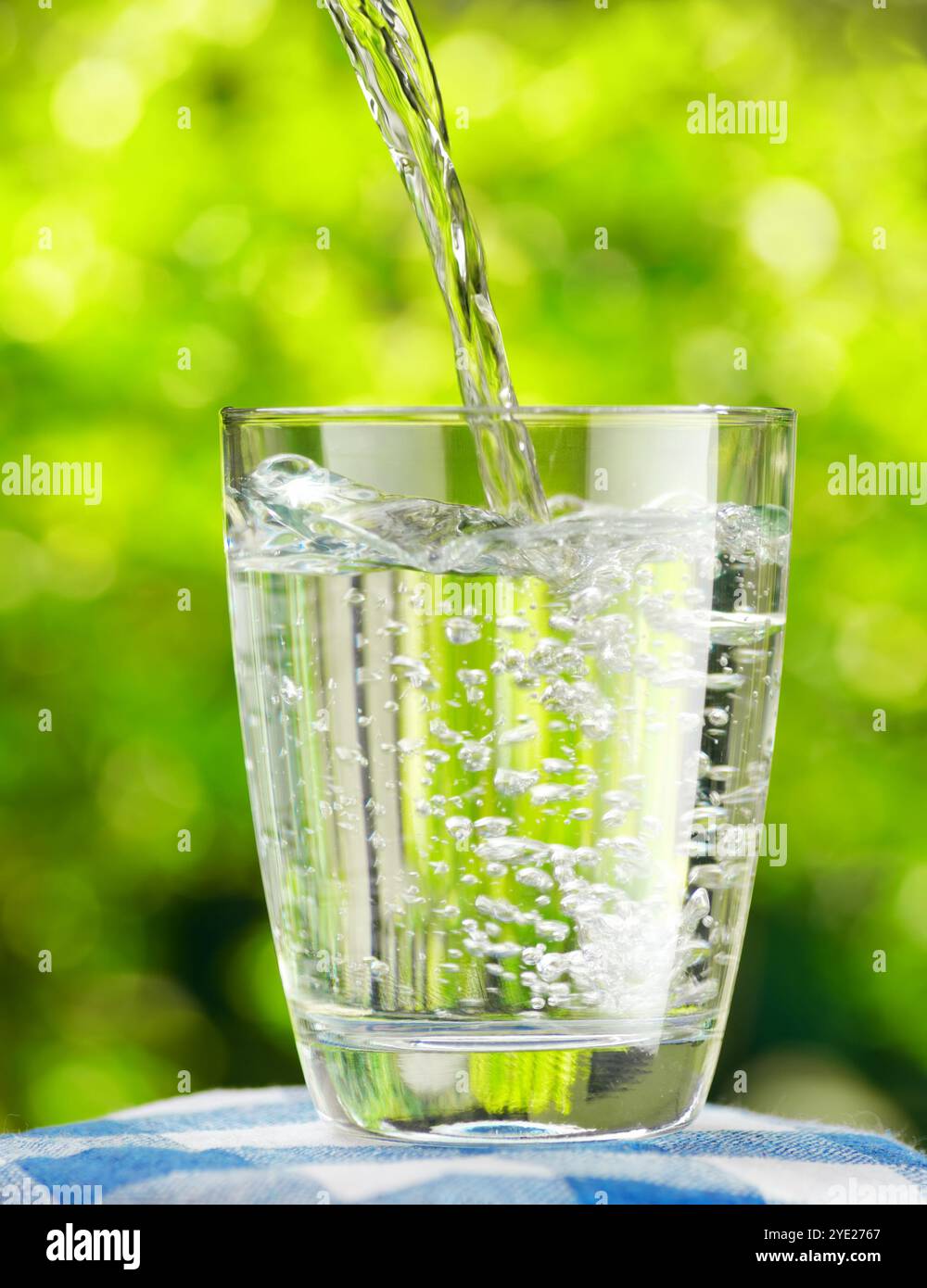 Glass of water on nature background Stock Photo - Alamy