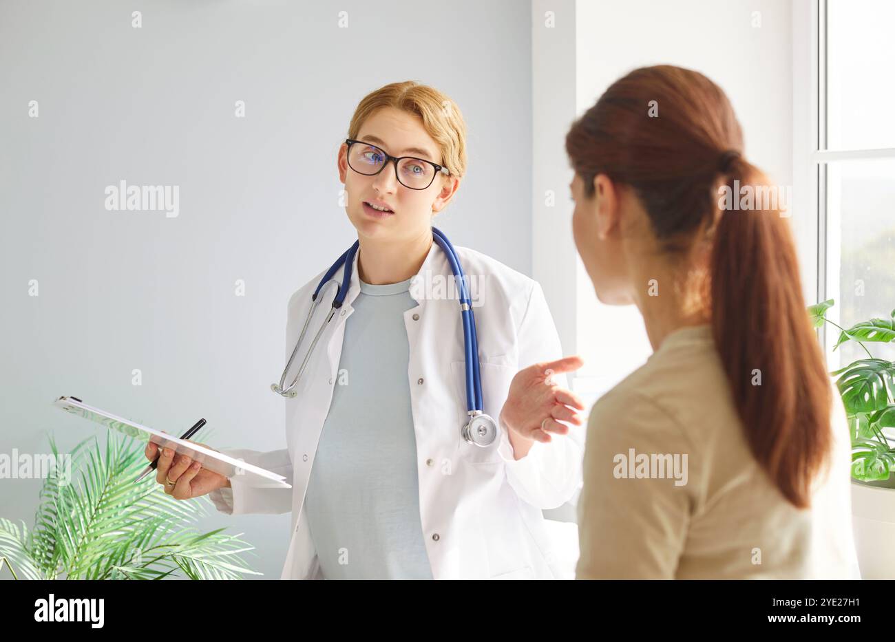 Female doctor talking sharing health tests laboratory results to female ...