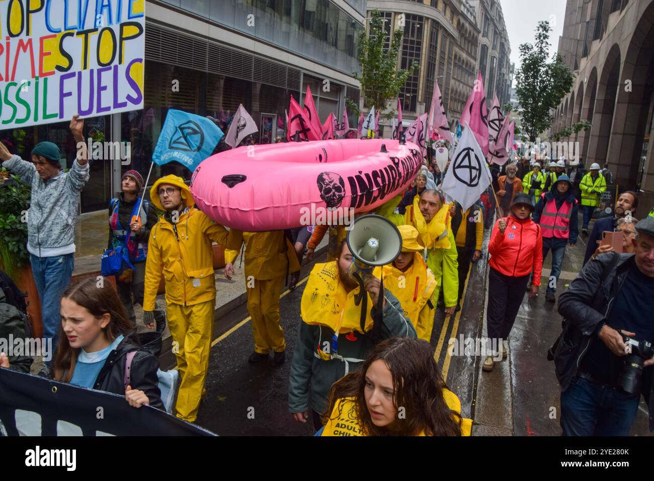 London, UK. 28th October 2024. Extinction Rebellion activists march in ...