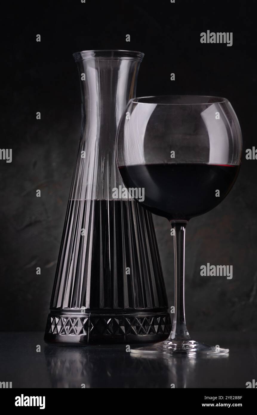 Decanter of wine and a glass on a dark background. Saperavi, Georgian ...
