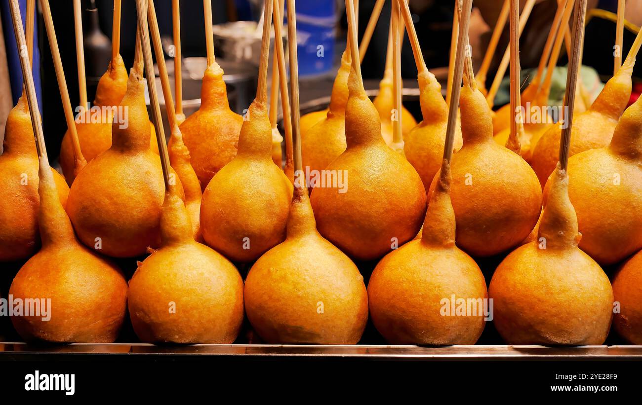 Roll of traditional Thai local dessert snack, deep fried dough called ...