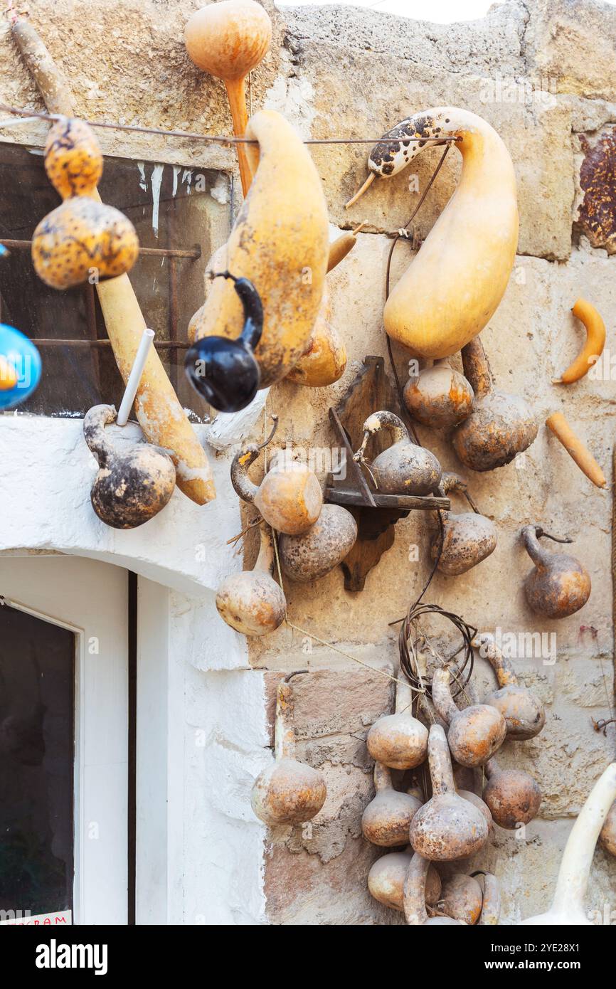 A group of dried gourds is hanging on a clay wall Stock Photo - Alamy