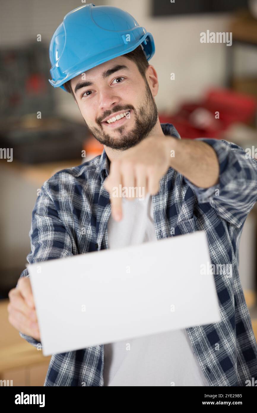 worker wearing hard hat and holding empty banner Stock Photo - Alamy