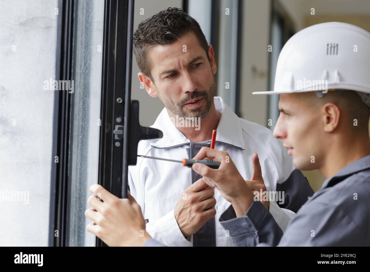 construction worker installing window in house Stock Photo - Alamy