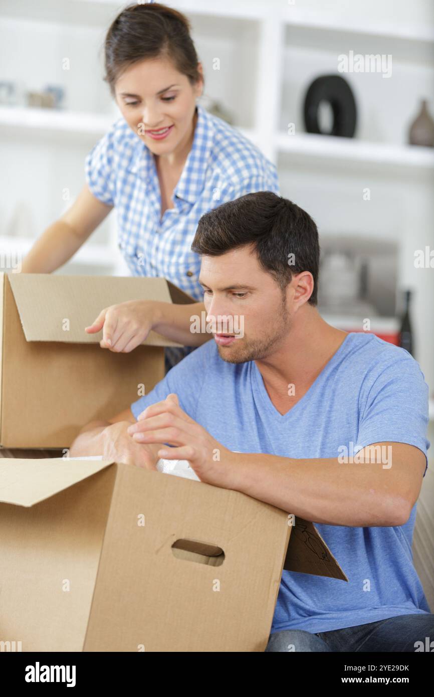young couple packing boxes for moving to a new home Stock Photo - Alamy