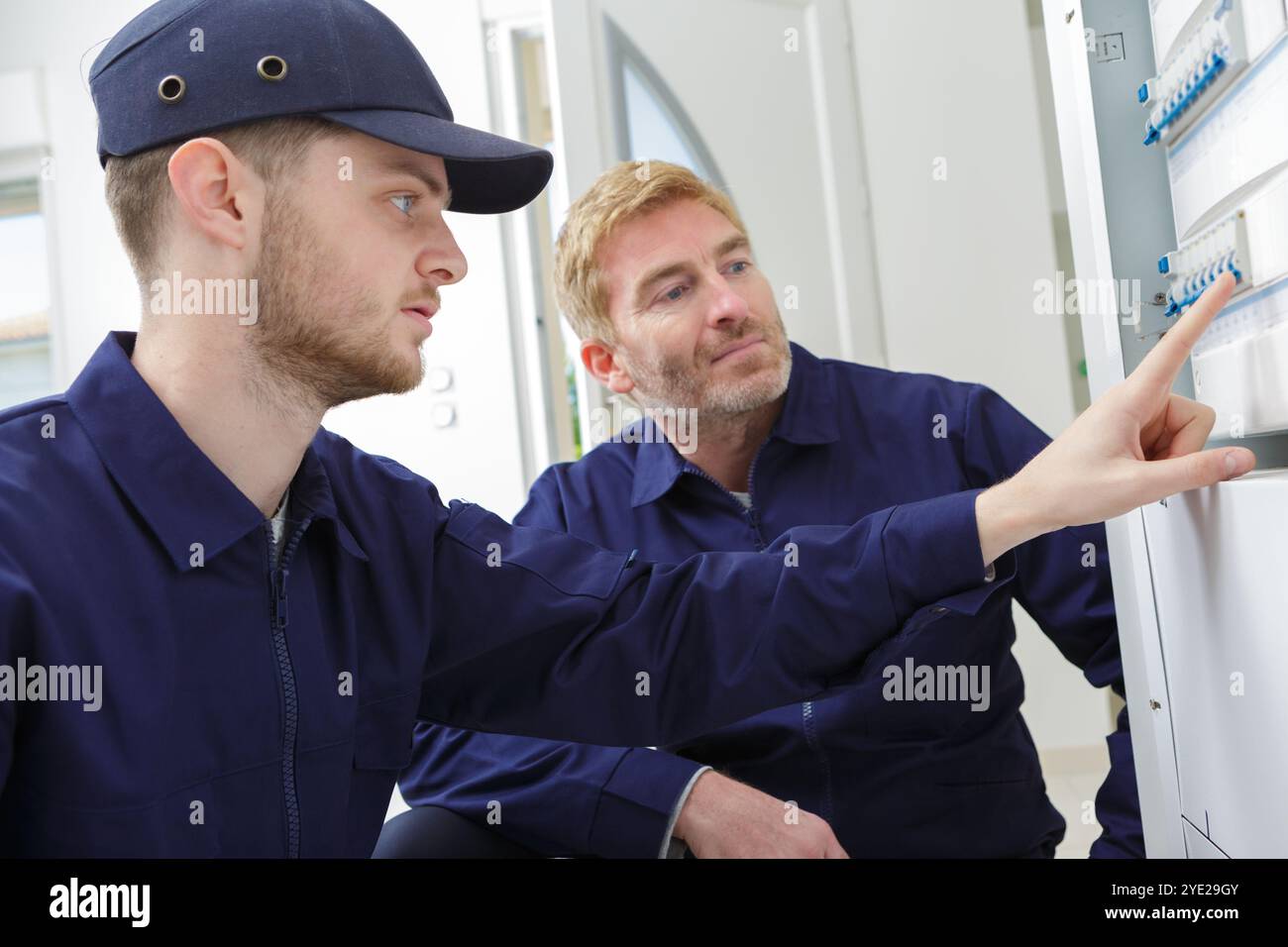 apprentice switching on an electrical panel Stock Photo - Alamy