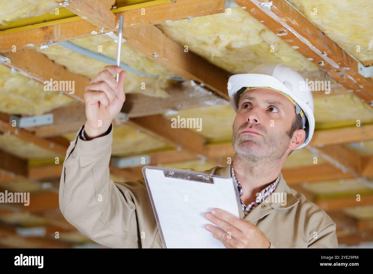 male builder pointing at ceiling Stock Photo - Alamy