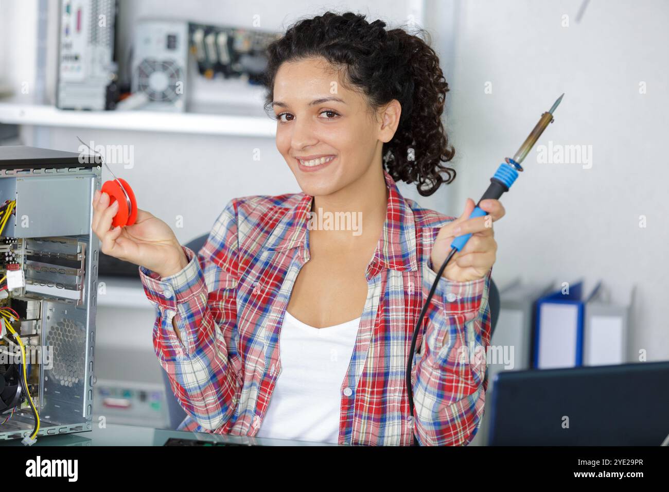 female engineer fixing broken computer hard drive Stock Photo - Alamy