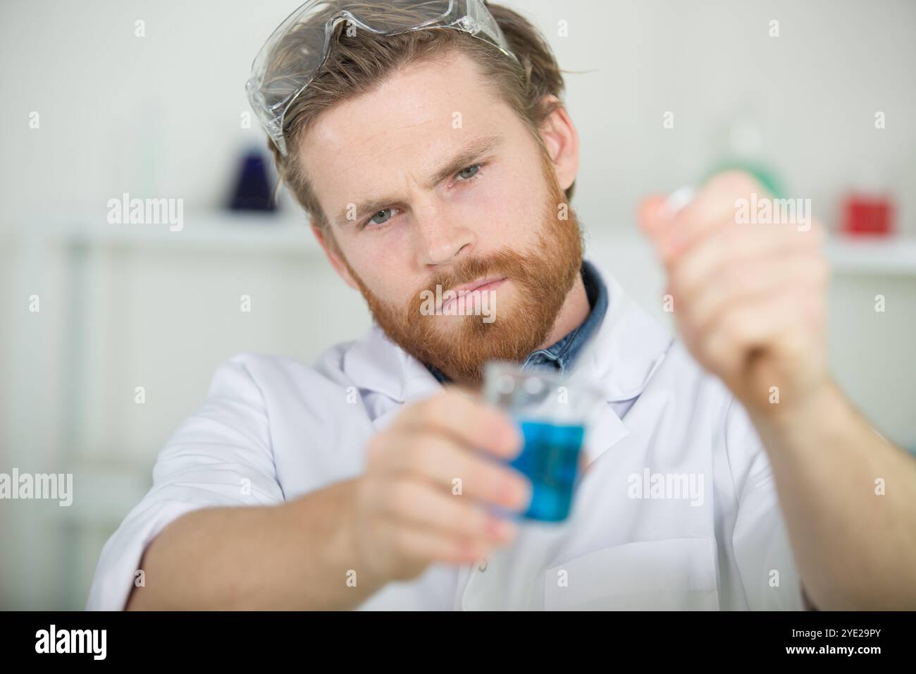 man checking liquids in the lab Stock Photo - Alamy