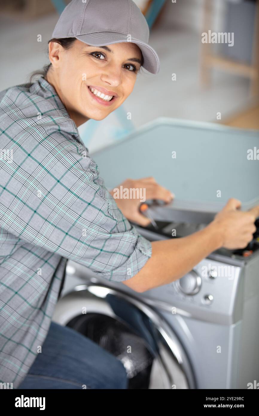 Woman repairing washing machine hi-res stock photography and images - Alamy