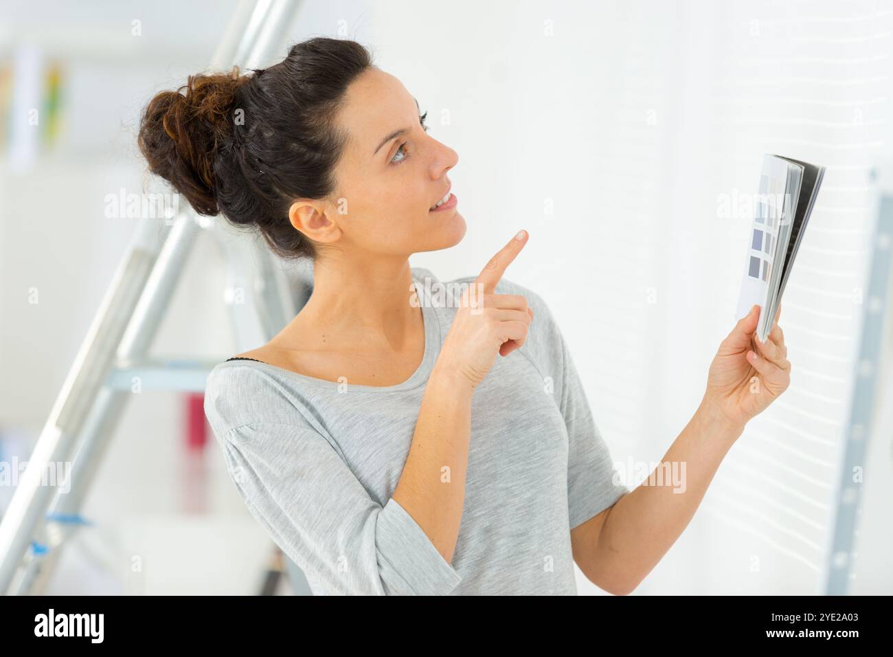 woman choosing paint color using sample Stock Photo - Alamy