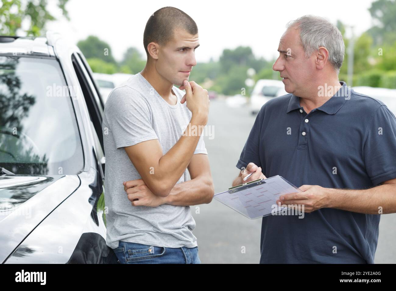 student driver with instructor filling forms before driving test Stock ...