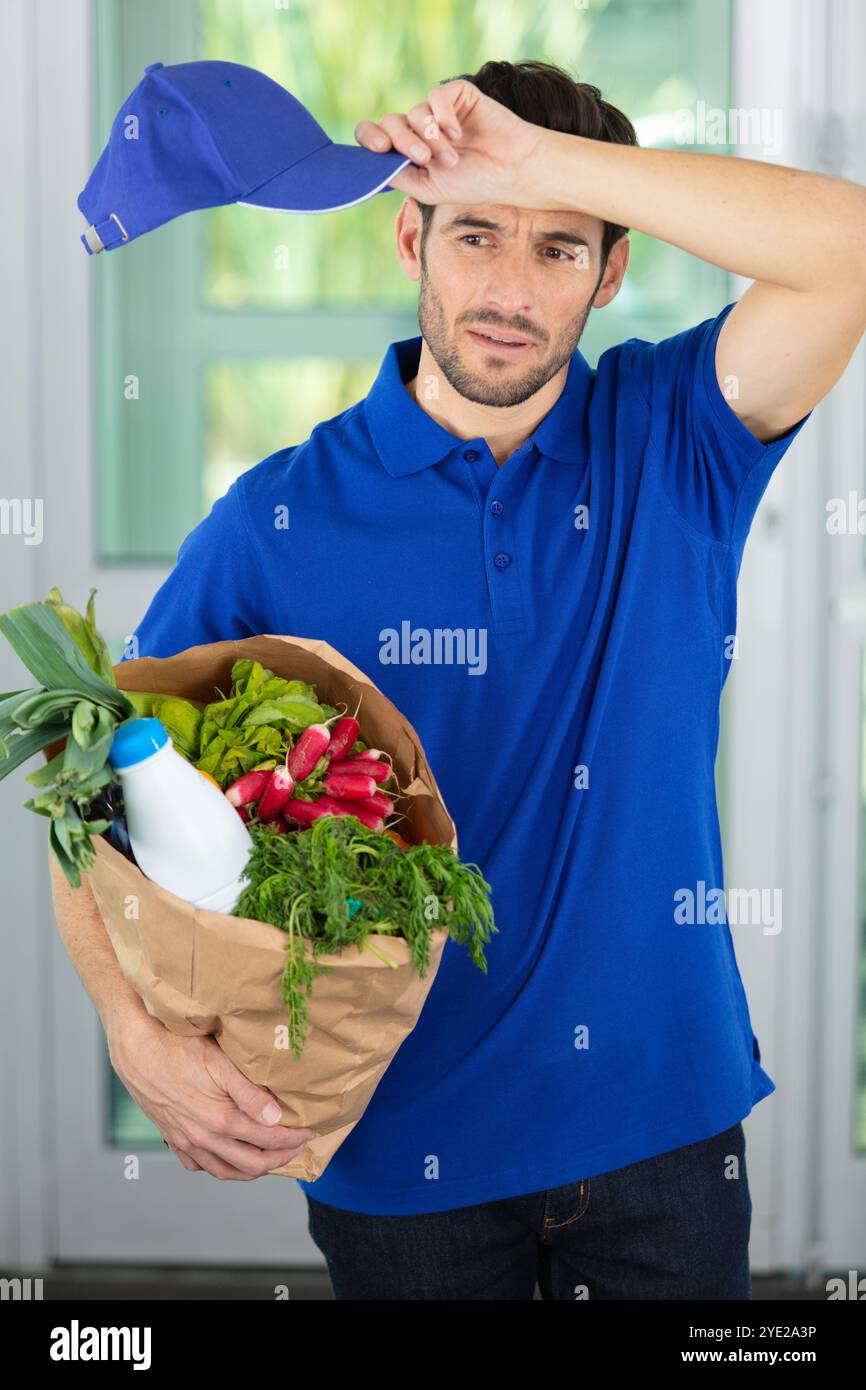 Tired young delivery man hi-res stock photography and images - Alamy