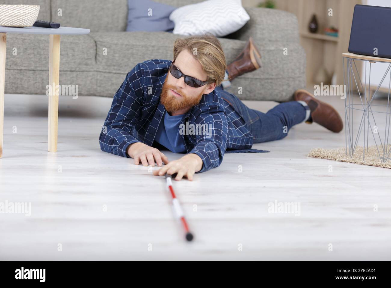 Young man falling on sofa hi-res stock photography and images - Alamy