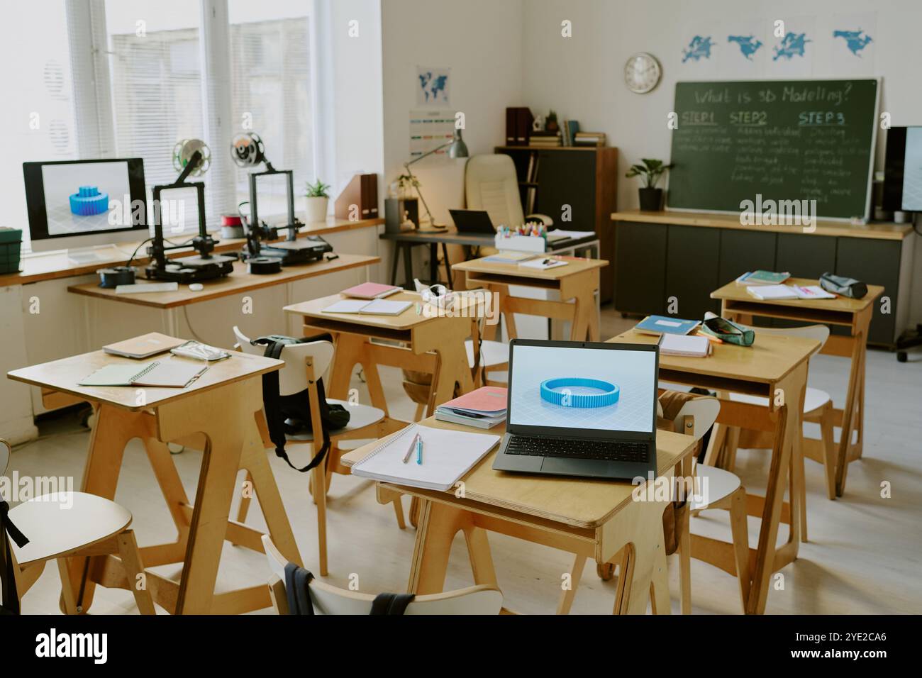 Education environment featuring laptops and 3D printers on wooden ...