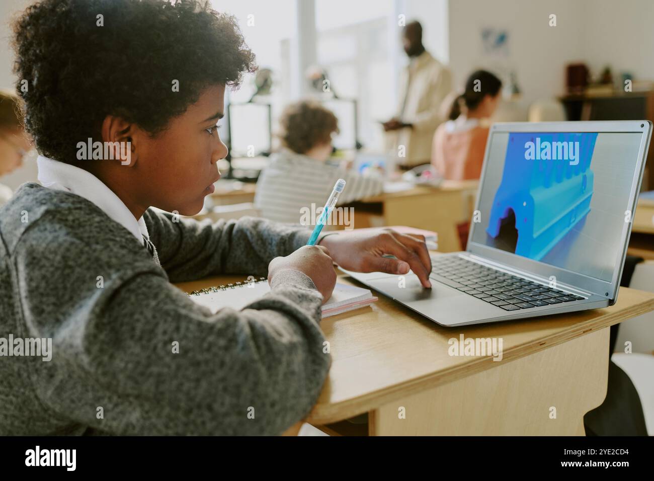 Young student working on an educational activity on laptop in modern ...