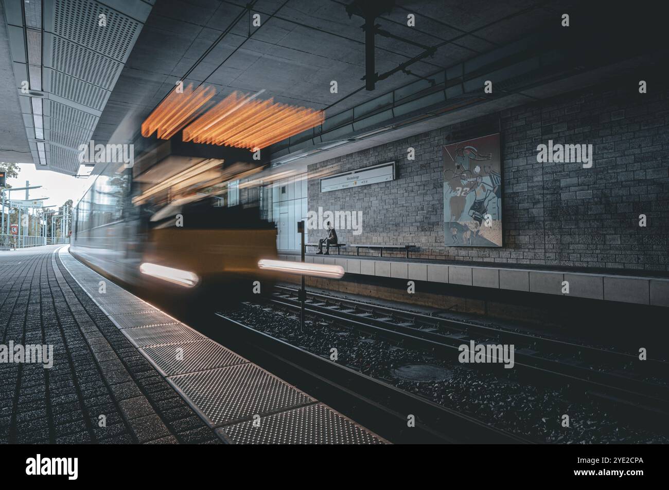 An underground railway moves through a modern, urban station with ...