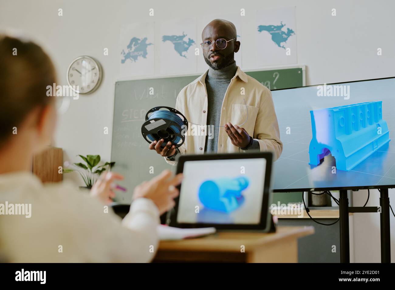 Man presenting virtual reality headset and discussing 3D model ...