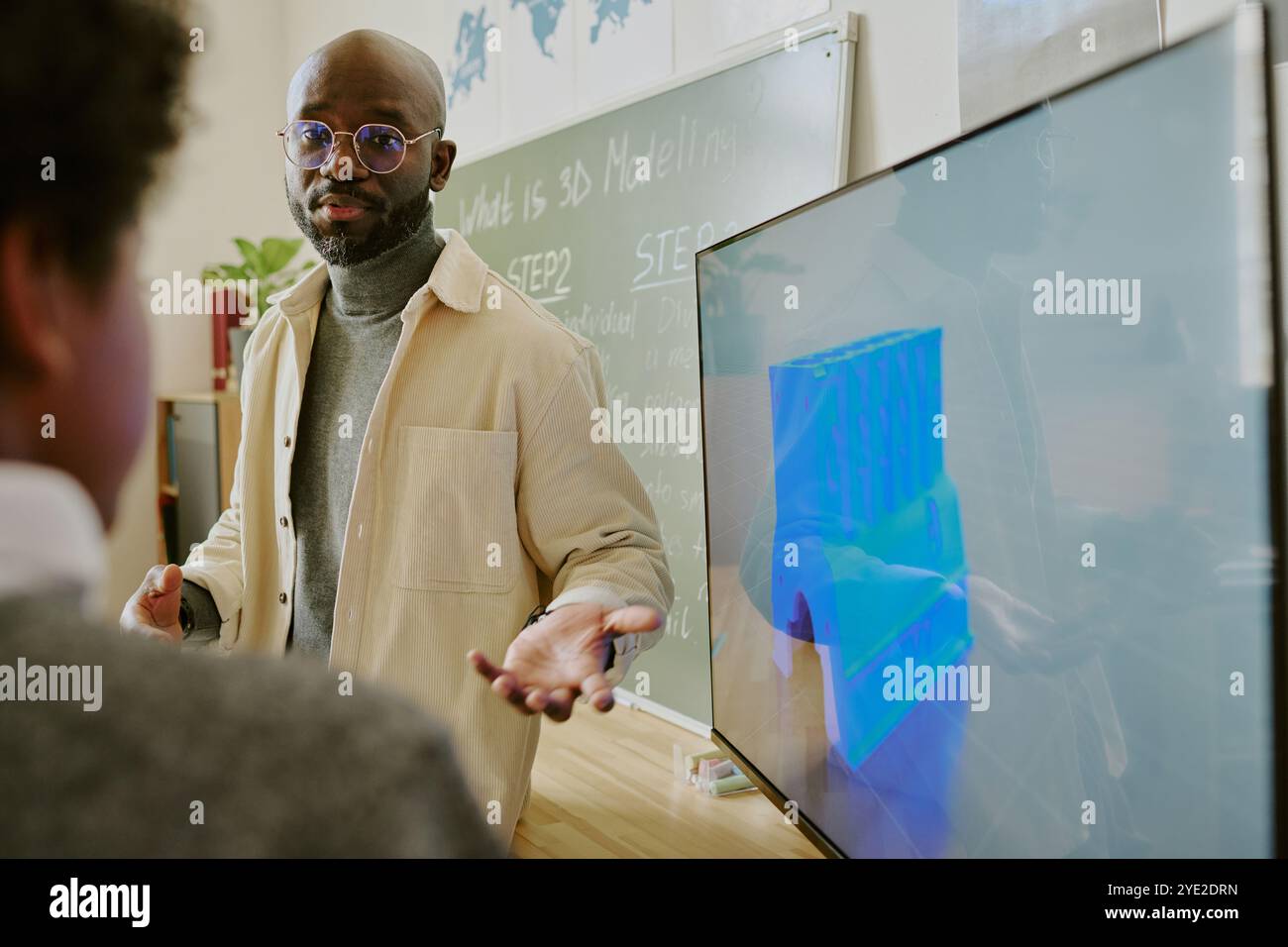 Educator explaining 3D modeling on interactive screen in classroom ...