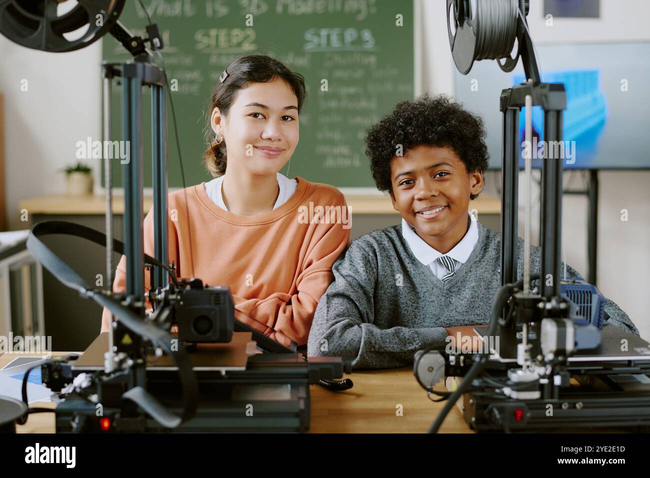 Multiracial students smiling while learning 3D printing technology in ...