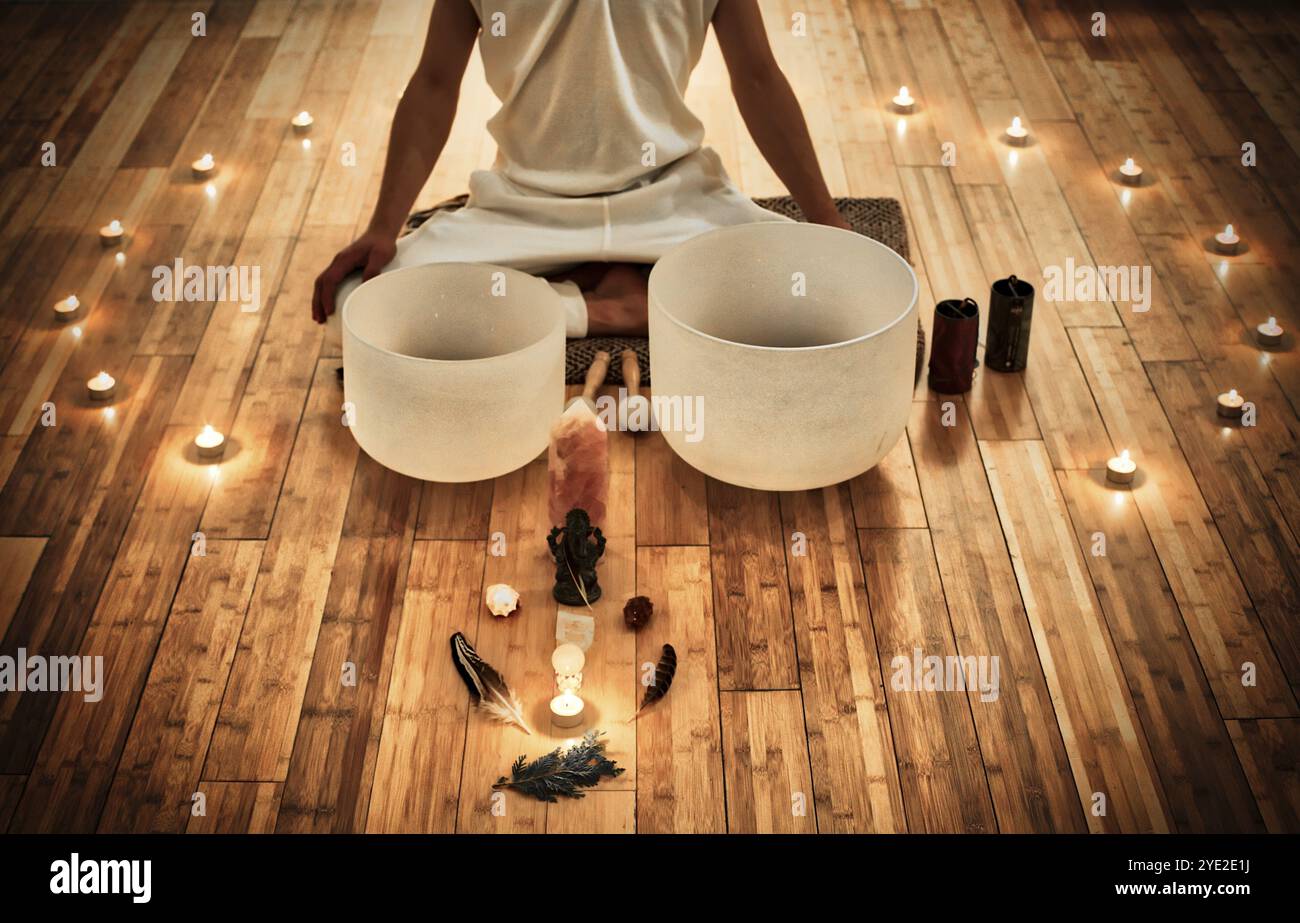 Man sitting in indian behind his two musical crystal bowls, with a ...