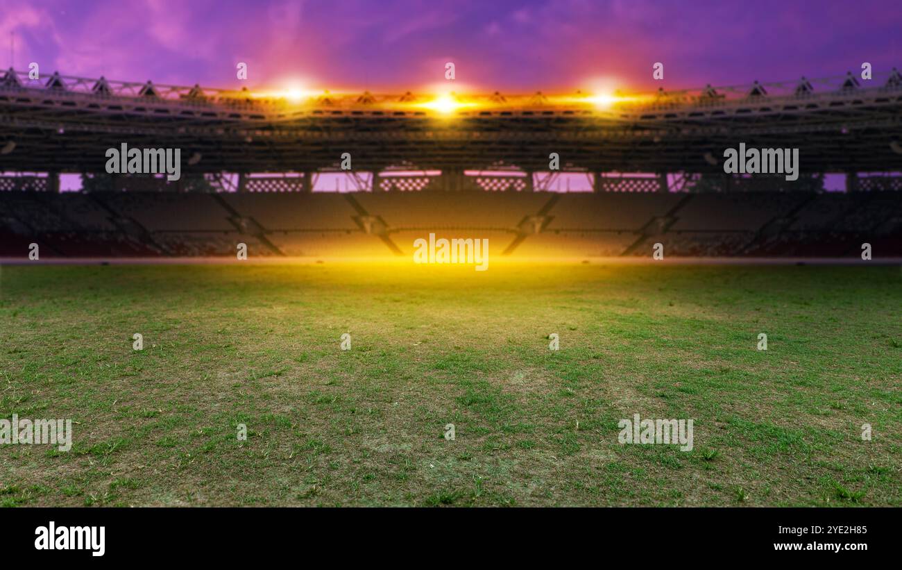 Empty football stadium with green field and spotlights. The field is ...