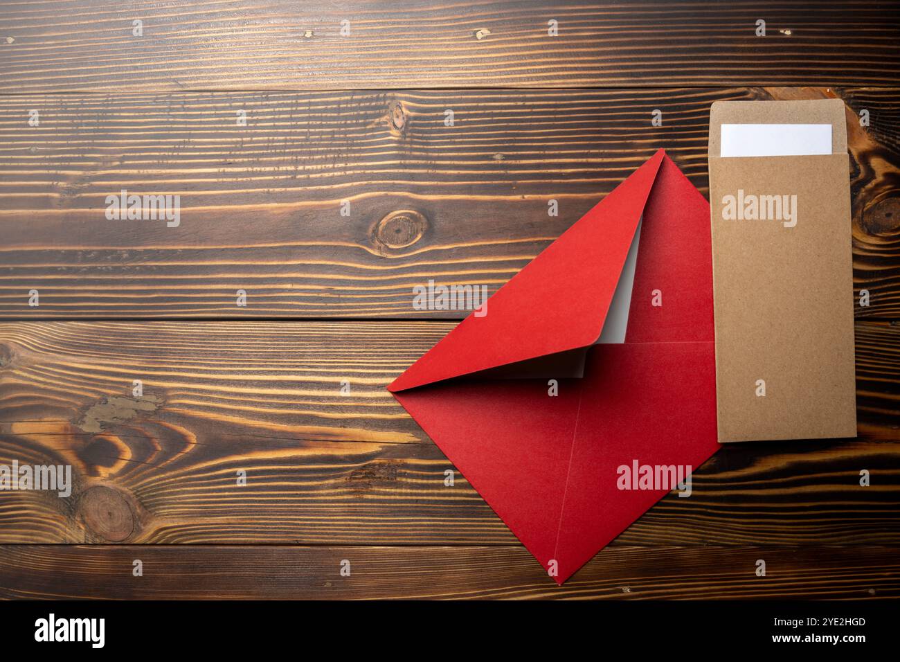 Top view of stack of two envelope and postcard on wooden background ...