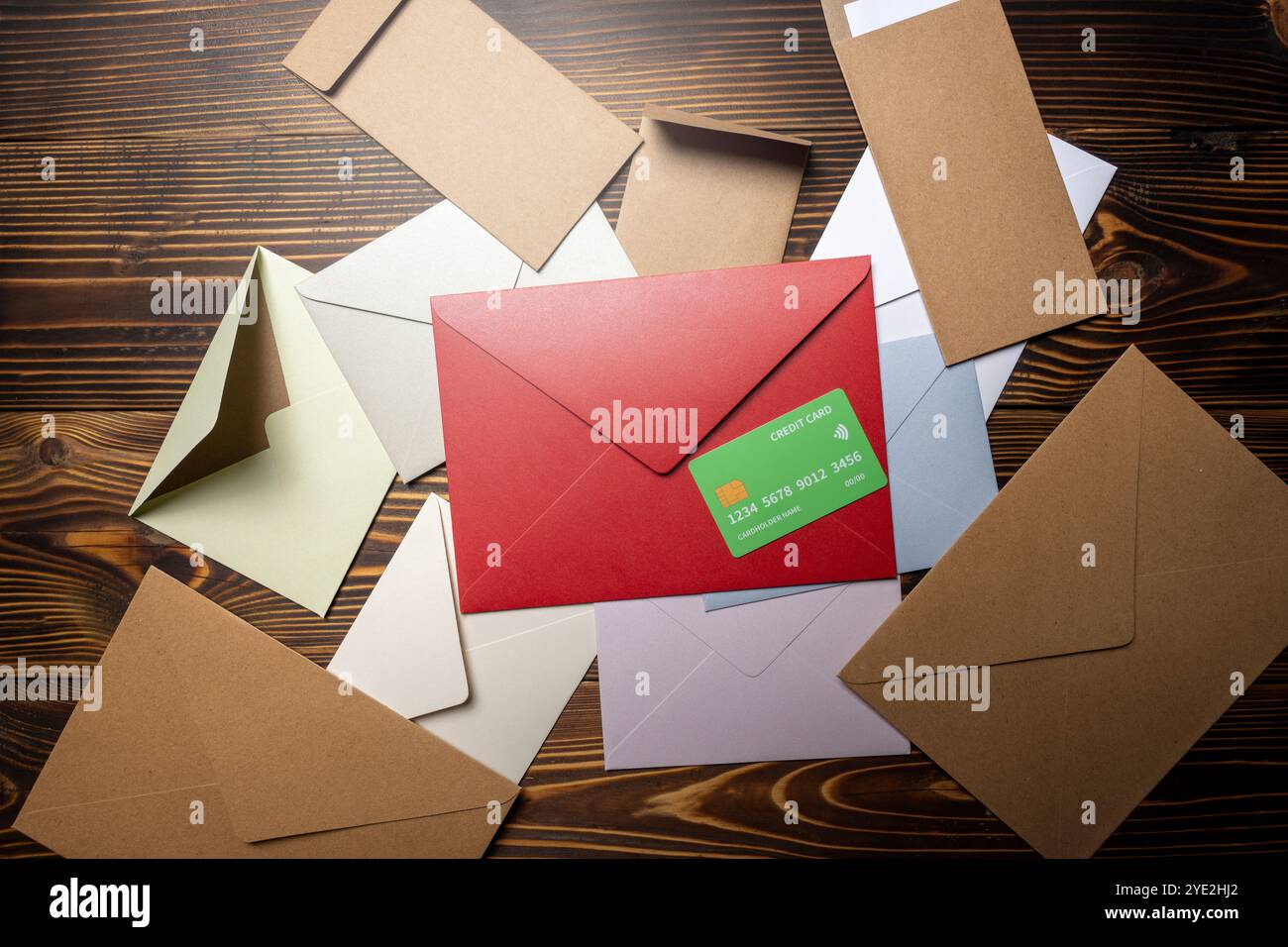 Top view of stack of envelope and postcard with credit card on wooden ...