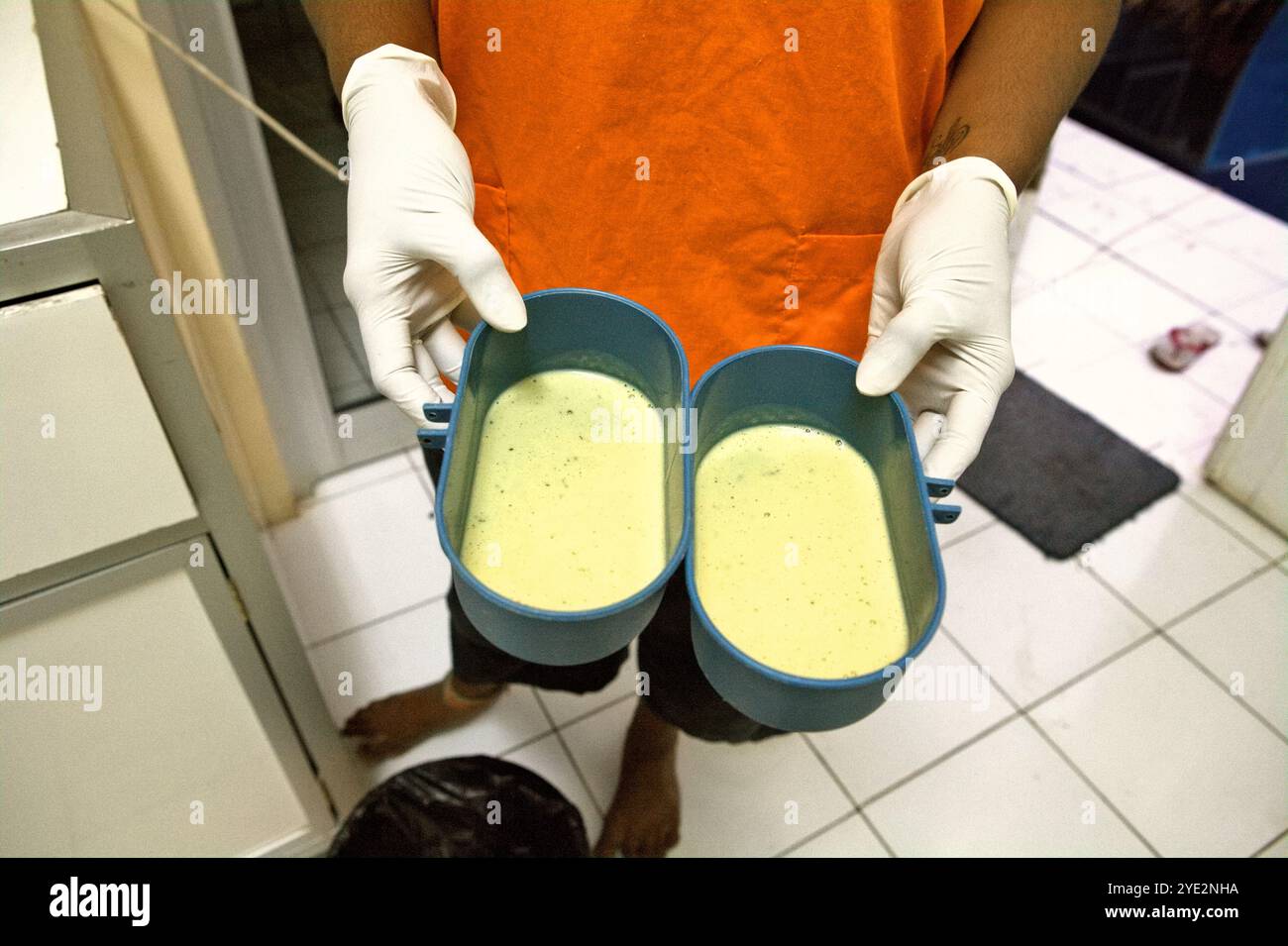 A veterinarian shows supplementary food to be given to a slow loris ...