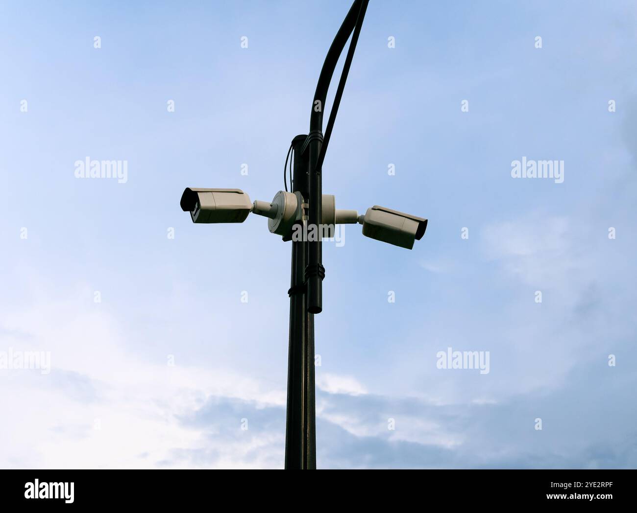CCTV cameras mounted on a pole against a cloudy sky Stock Photo - Alamy