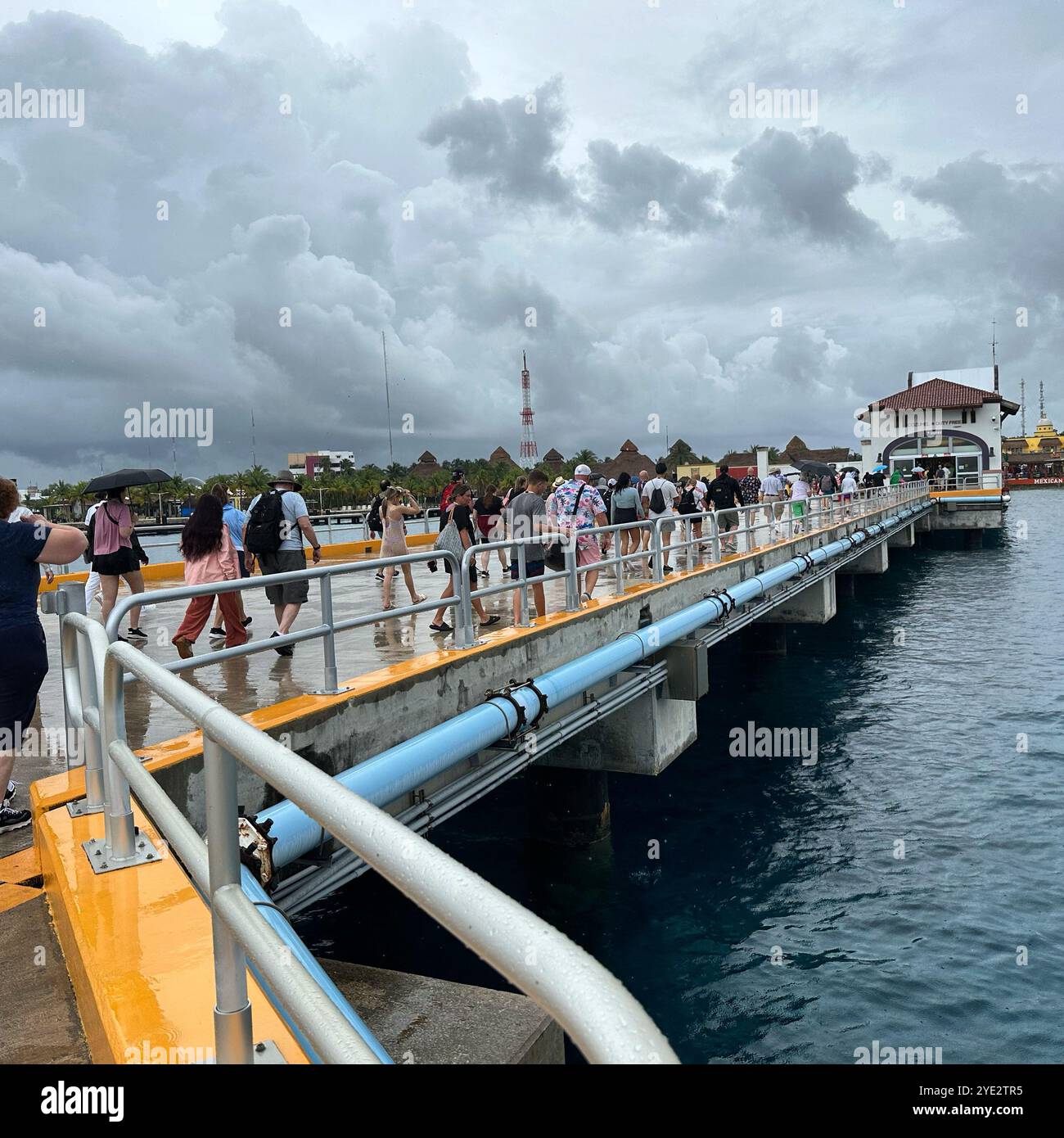 Cruise ship passengers walkiing down Puerta Maya Pier, Cozumel ...