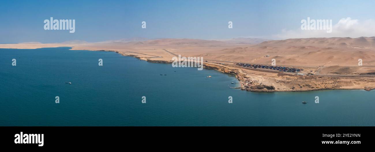 A beautiful blue ocean with a sandy beach and a small town in the ...
