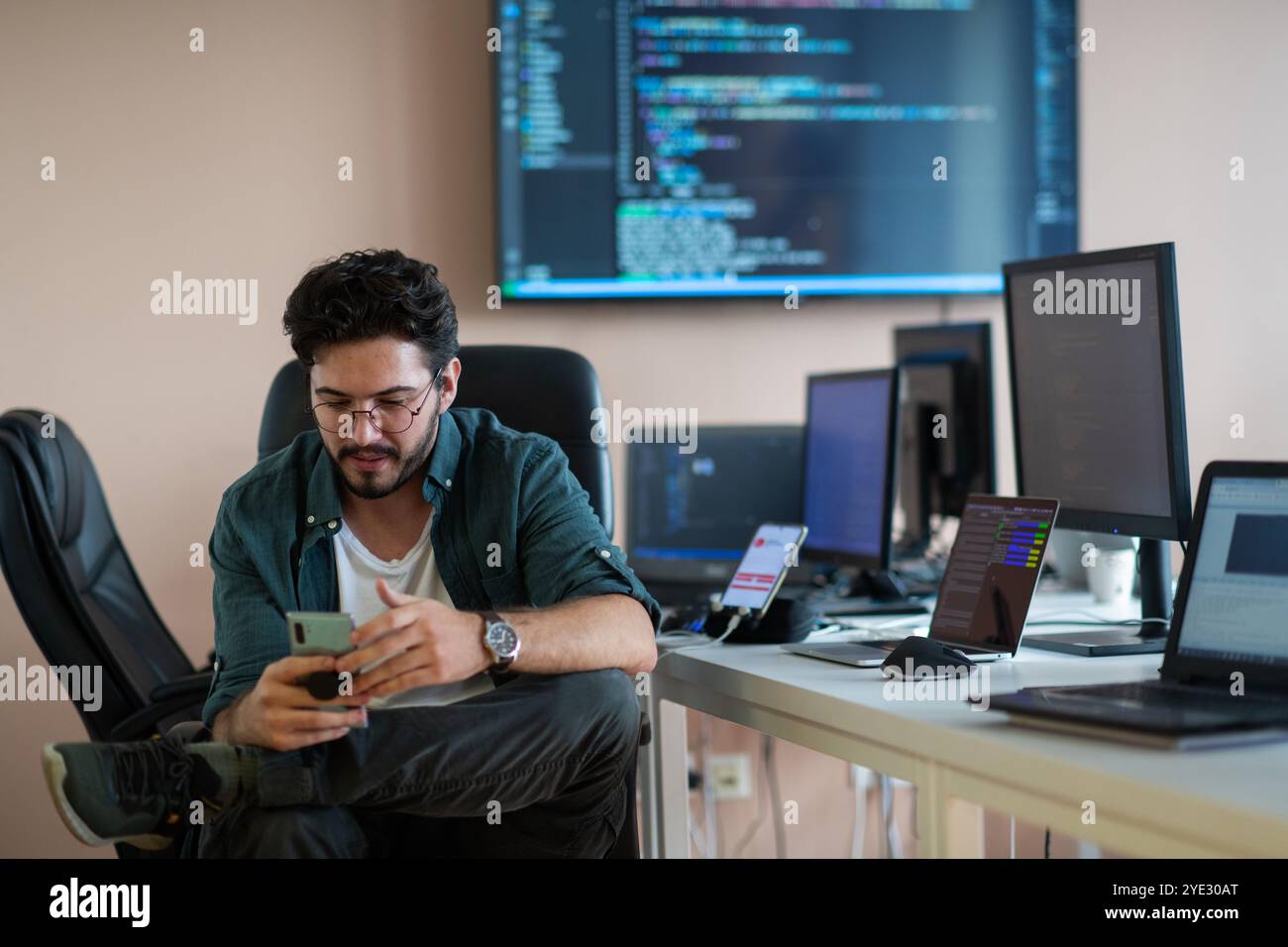 A programmer diligently testing smartphone applications Stock Photo - Alamy